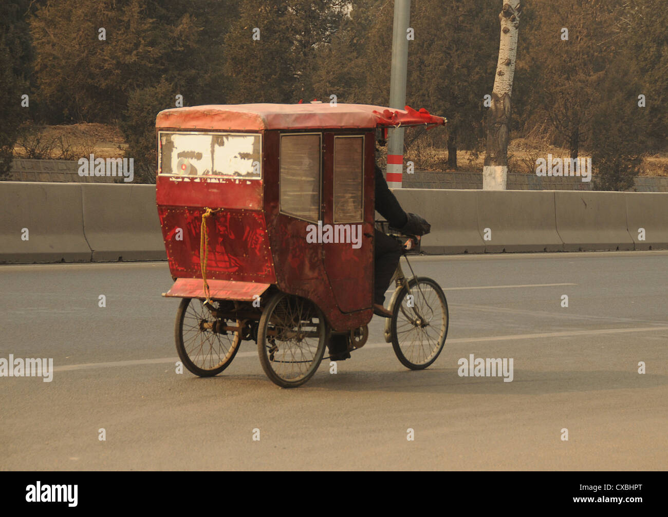 Three wheel covered Rickshaw on Beijing street Stock Photo - Alamy