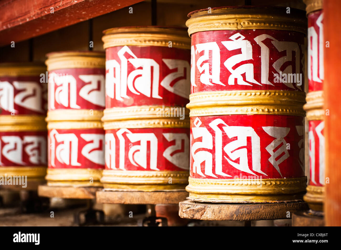 Buddhist prayer wheels in Tibetan monastery with written mantra. India ...