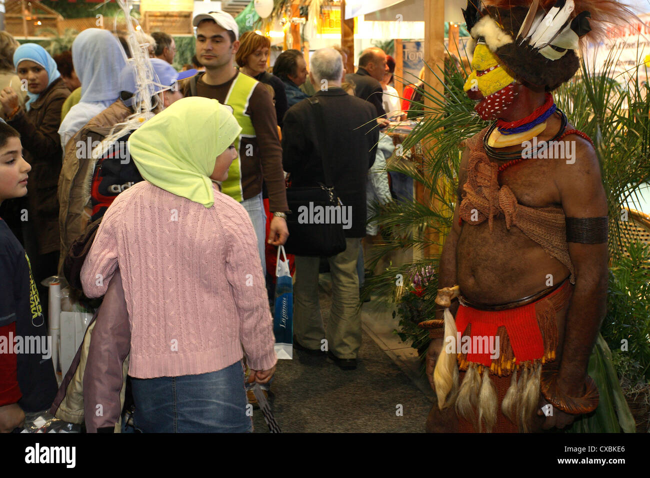 ITB Berlin 2007: Muslim girl looks at a man from Papua New Guinea Stock ...
