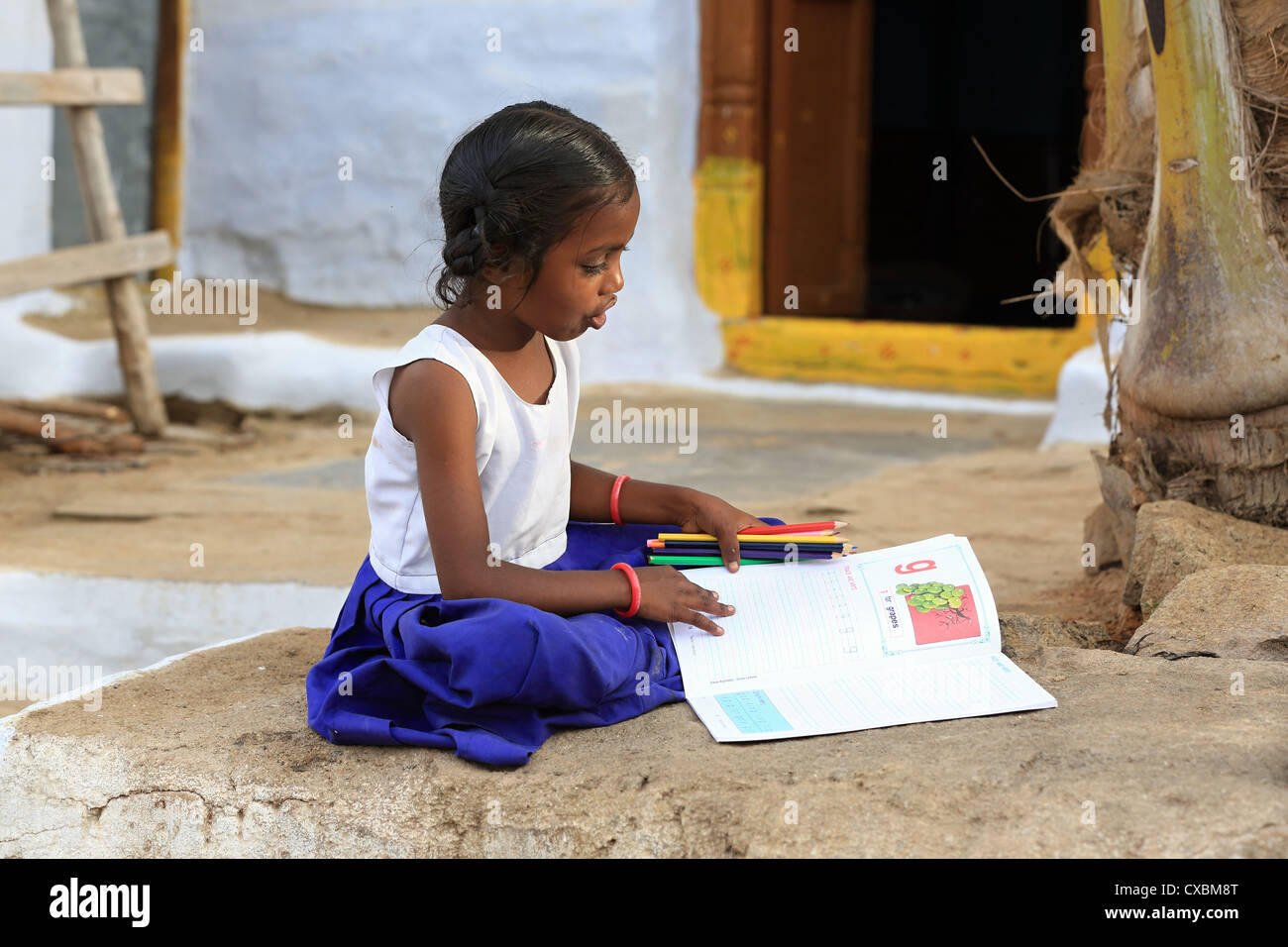 Indian school girl reading alphabet letters Andhra Pradesh South India ...