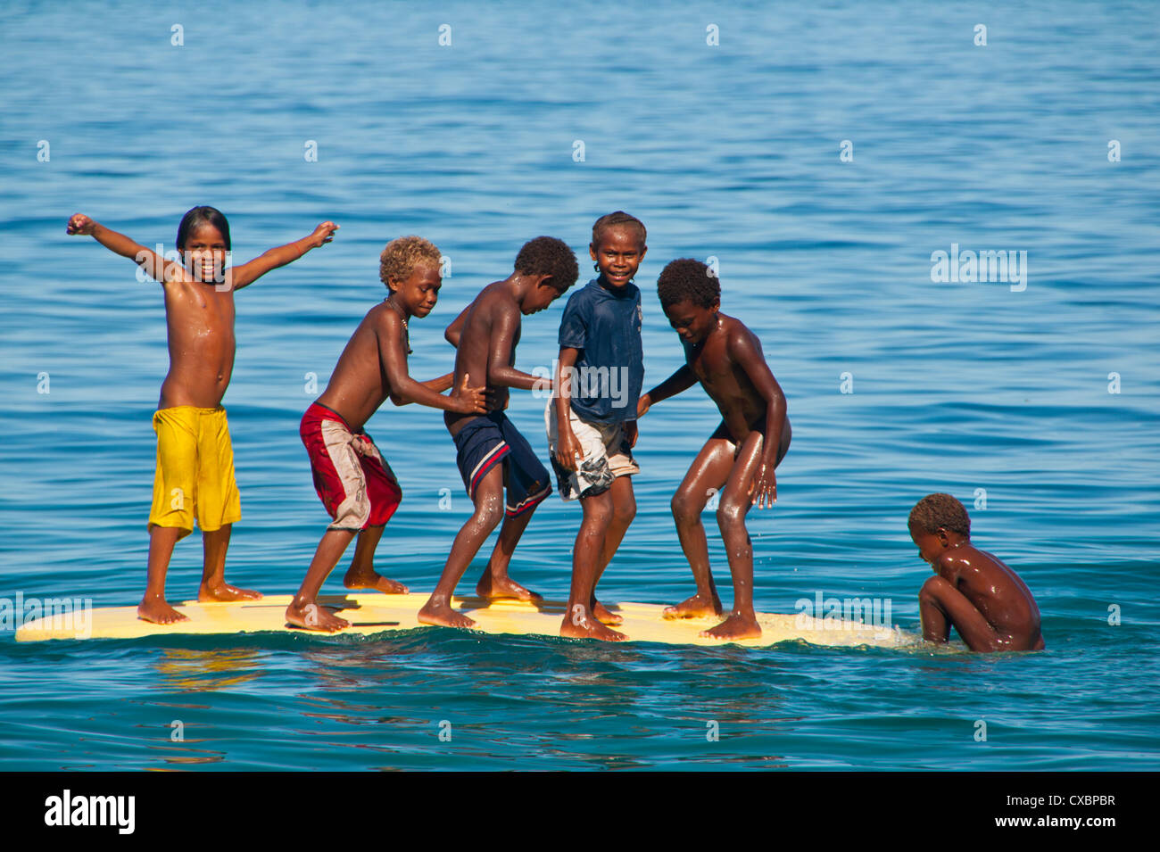 Happy children playing on the beach of Savo island, Solomon Islands ...