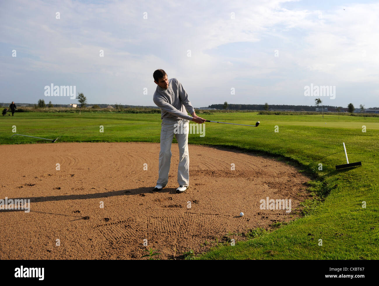 Golf player makes a sand shot Stock Photo - Alamy