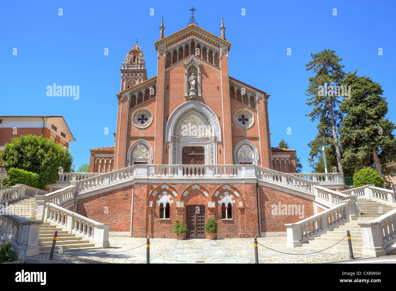 White stairs leading towards beautiful red catholic church under blue ...