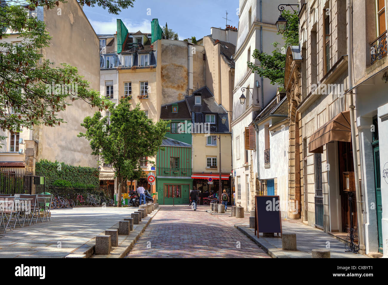 View on narrow cobbled street among traditional parisian buildings in ...
