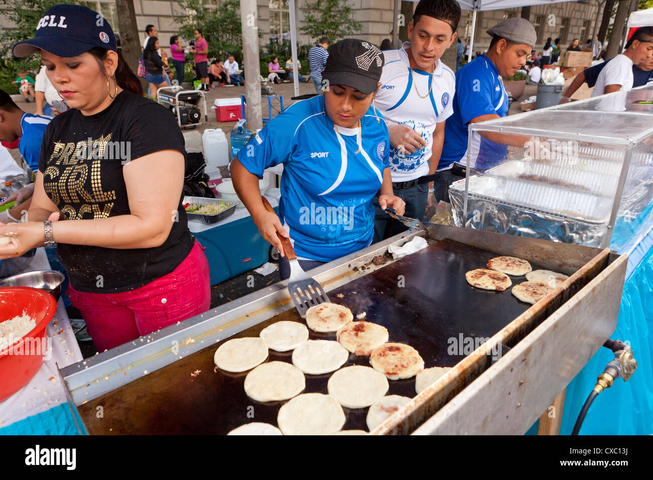A woman grilling pupusas Stock Photo - Alamy