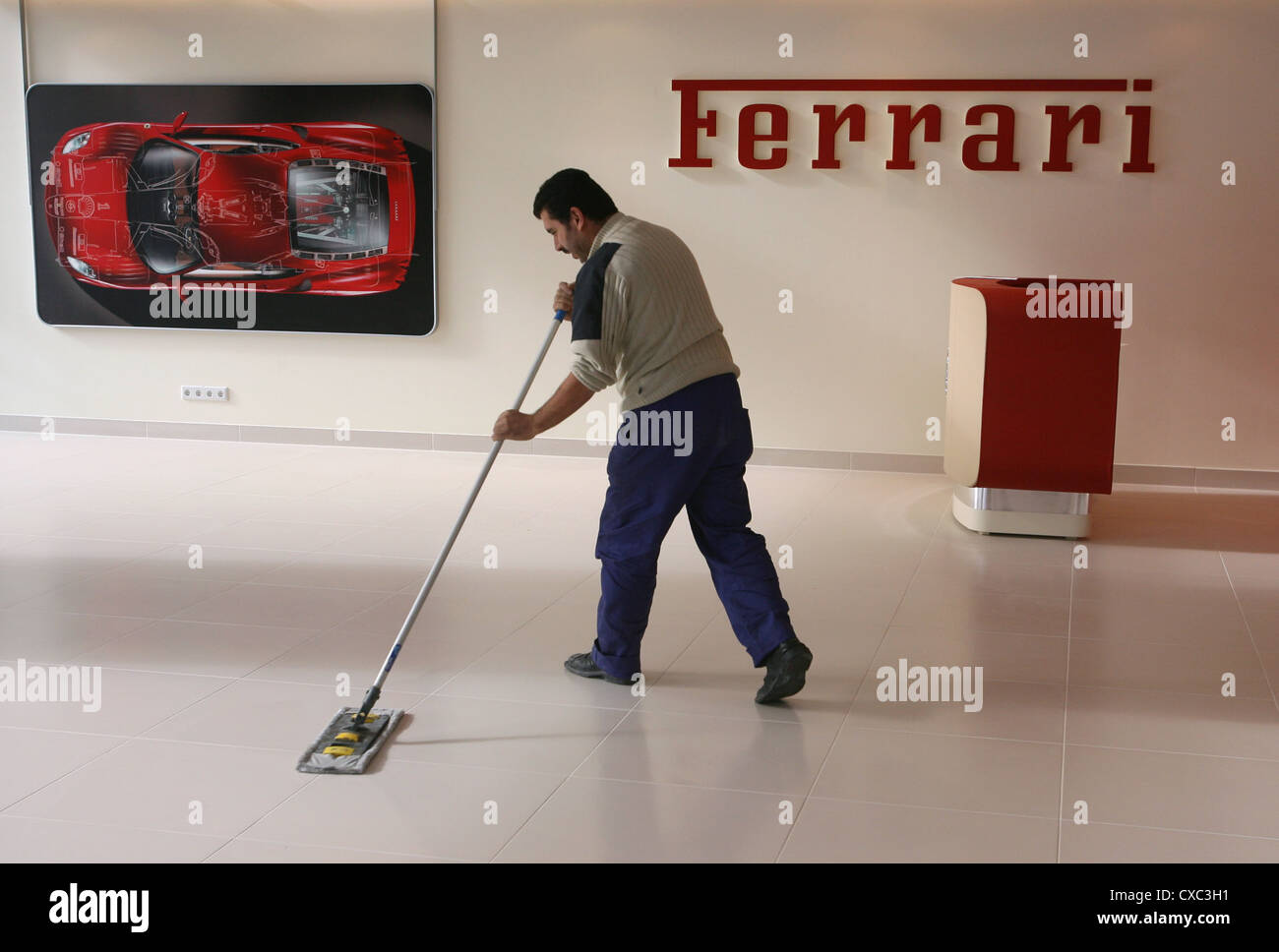 Berlin A man cleans at Ferrari Stock Photo - Alamy
