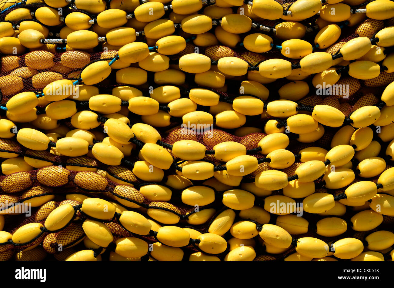 Background of yellow floats of fishing net Stock Photo - Alamy
