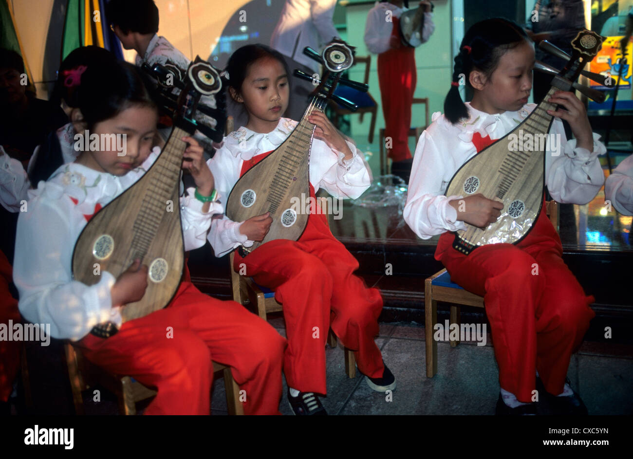 China, Shanghai, music, 3 young female children playing 'Liuqin ...