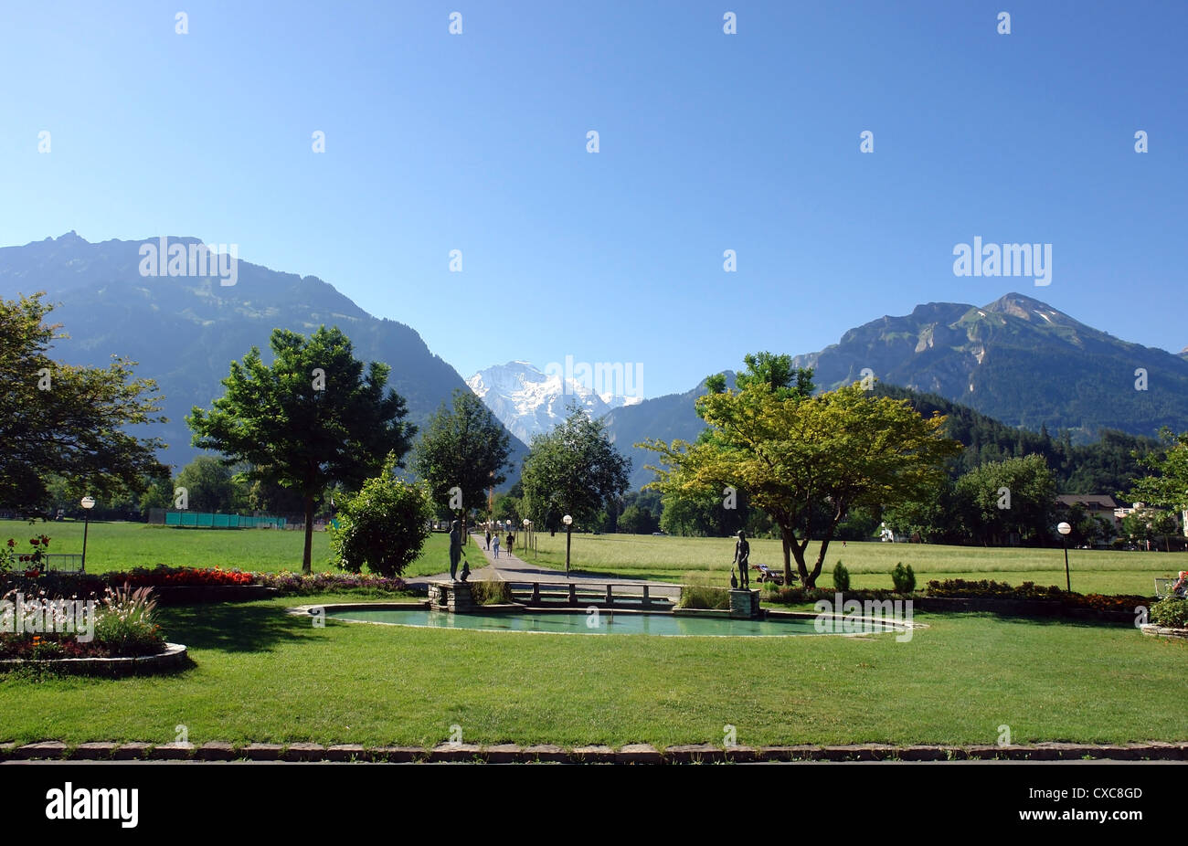 An open field in Interlaken with a view of the mountains in the ...