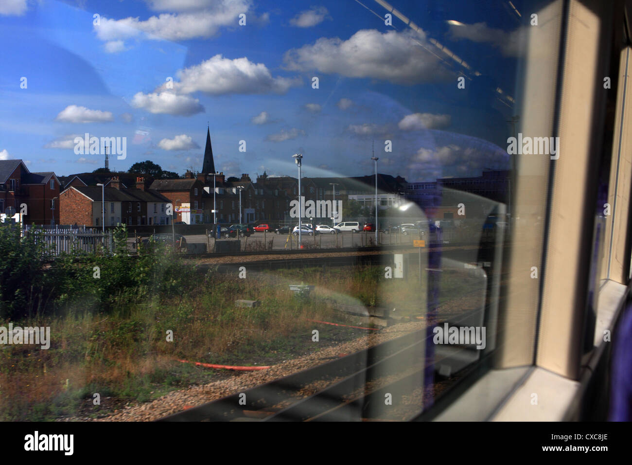 a view through a traveling train window taken as the train travels ...