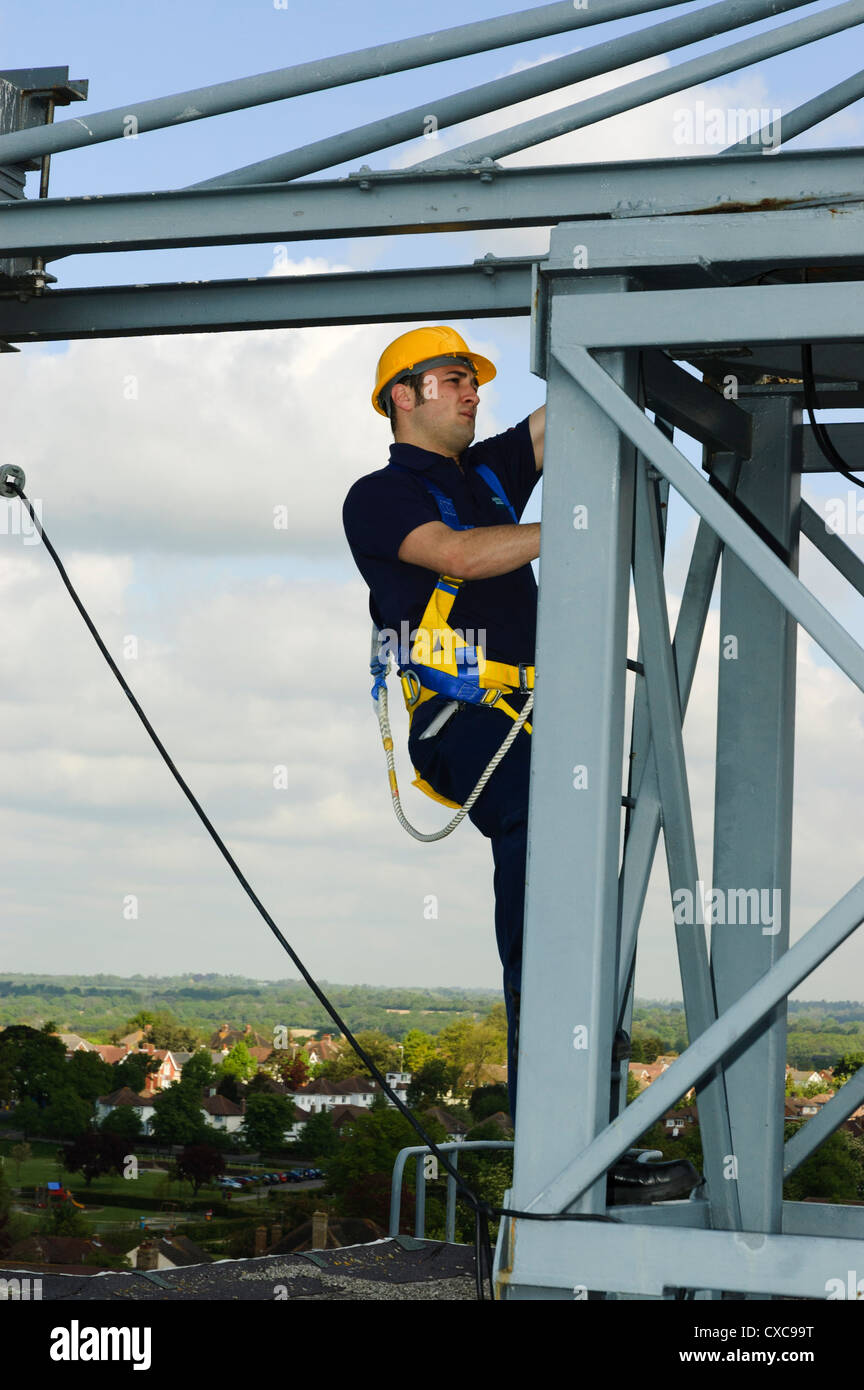 engineer with safety equipment climbing outside steelwork Stock Photo ...