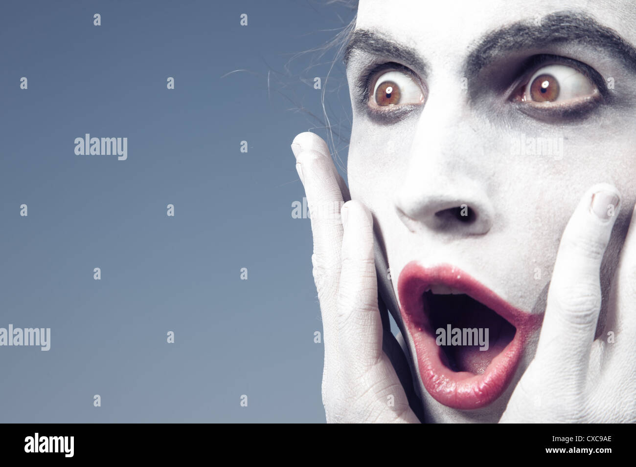 Man with white makeup expressing shock Stock Photo - Alamy