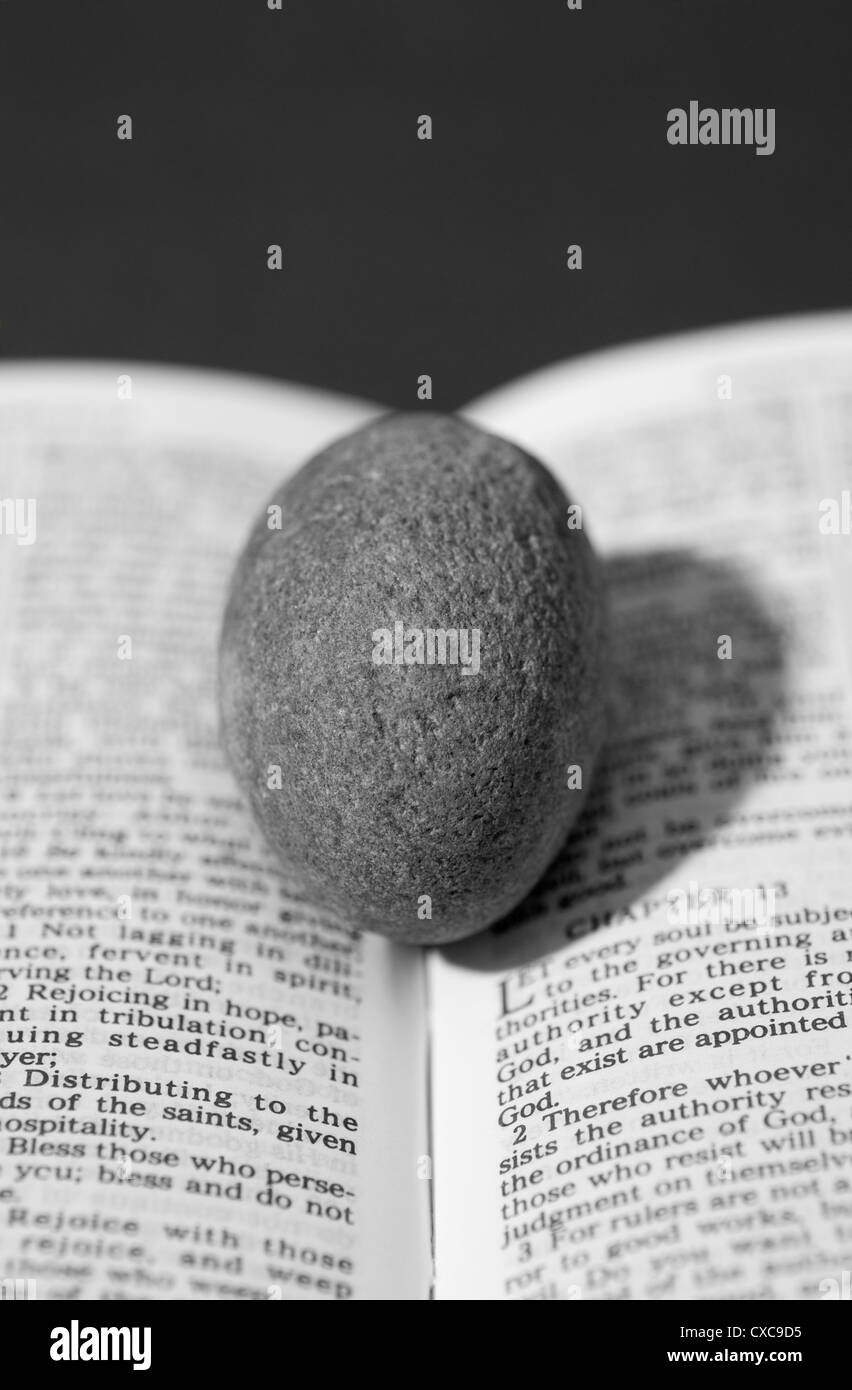 Stone on book pages Stock Photo - Alamy
