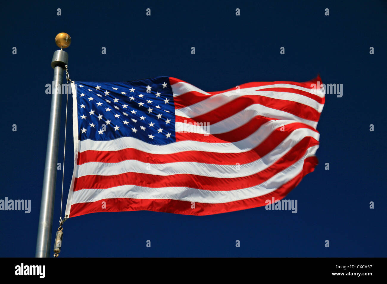 The Star Spangled Banner flying against a blue sky background in ...