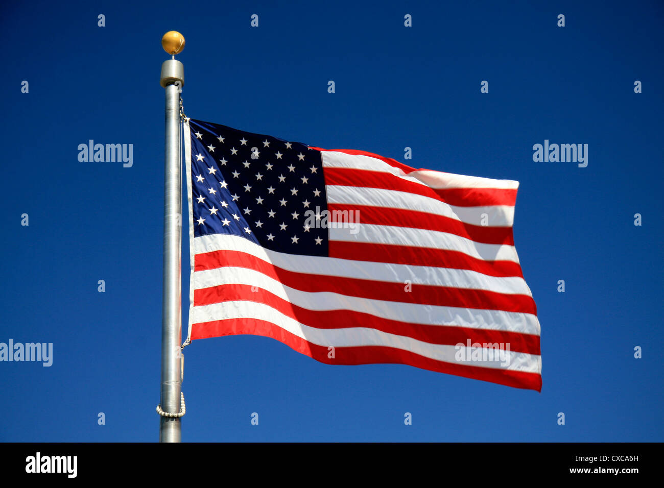 The Star Spangled Banner flying against a blue sky background in ...