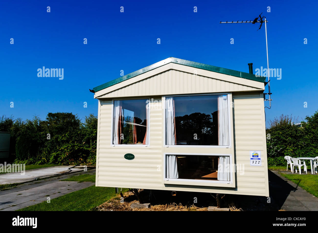 The early morning sun reflects brightly off the front of a cream ...