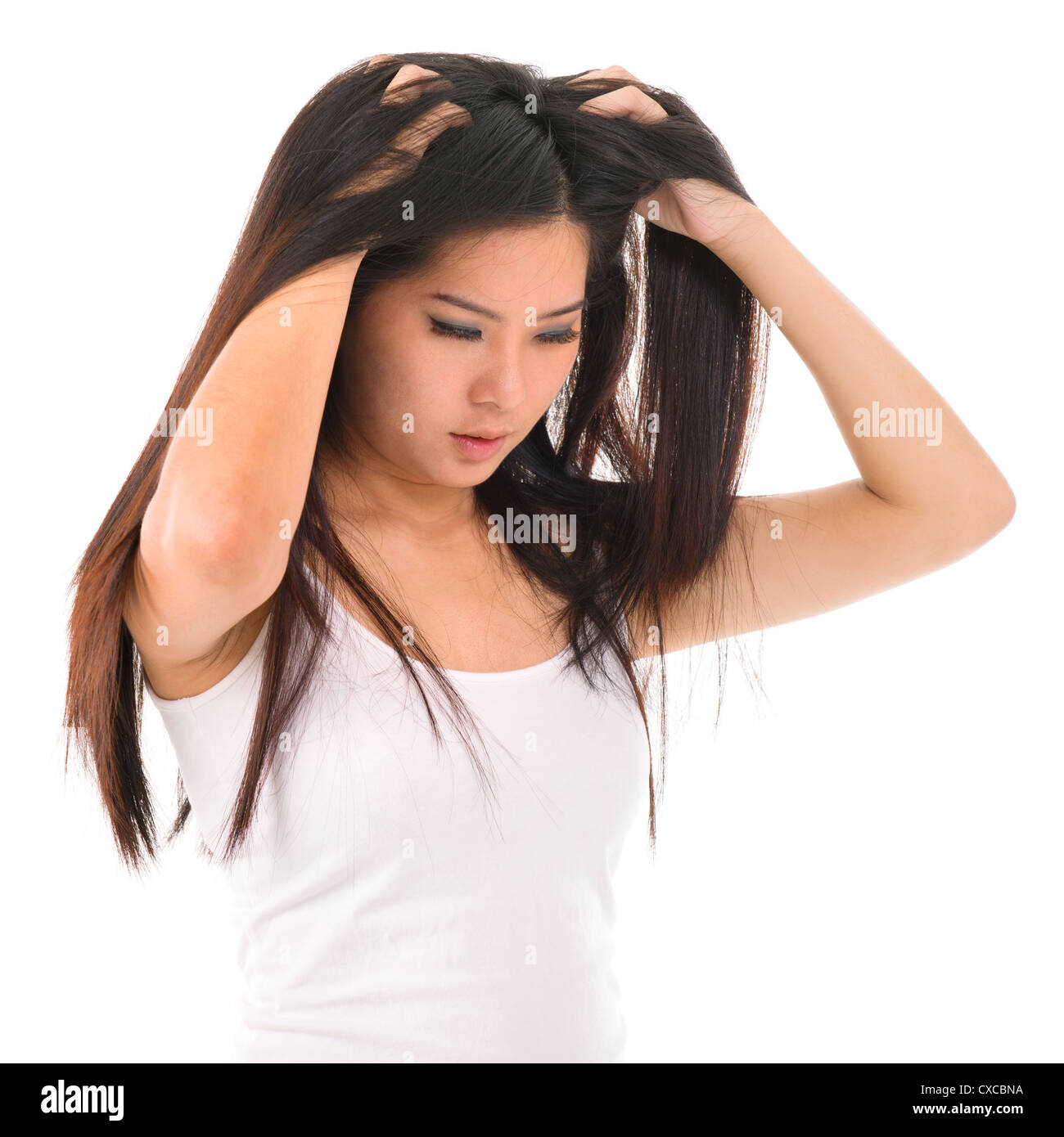 Young Asian girl scratches her hair on white background Stock Photo - Alamy