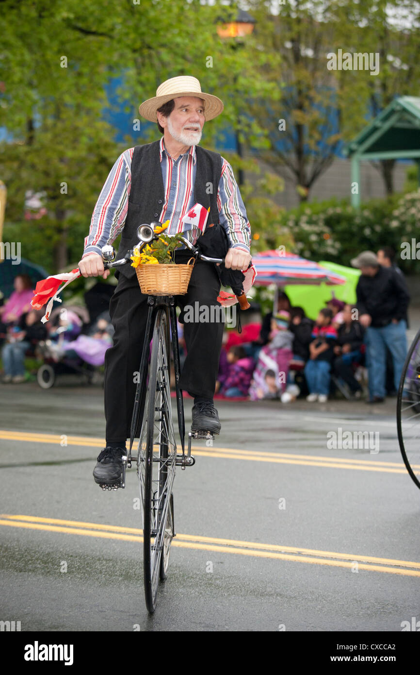 Man riding penny farthing bicycle during 2012 Victoria Day Parade ...