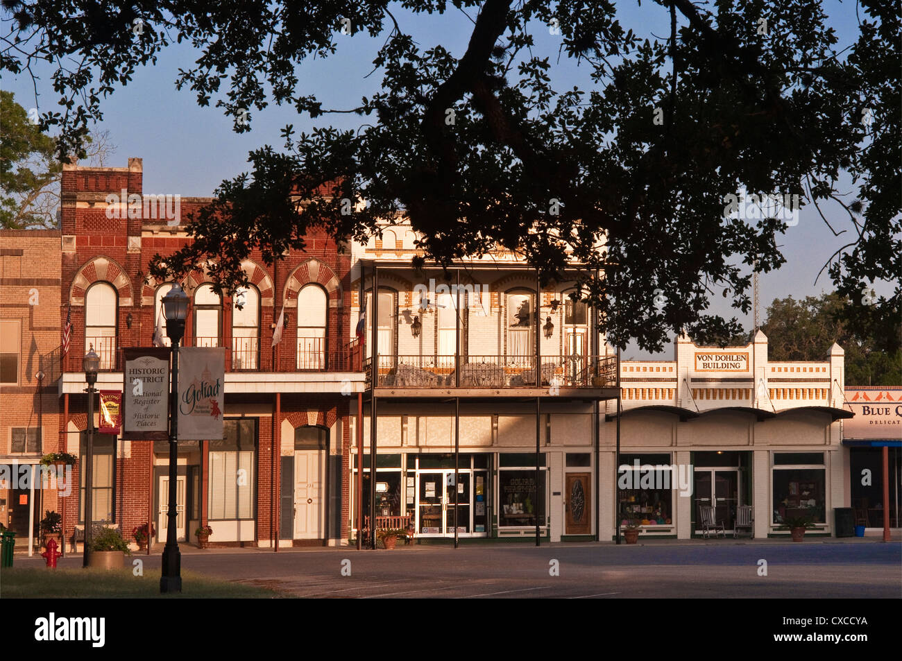 Shops in Courthouse Square, seen through branches of Hanging Tree live ...