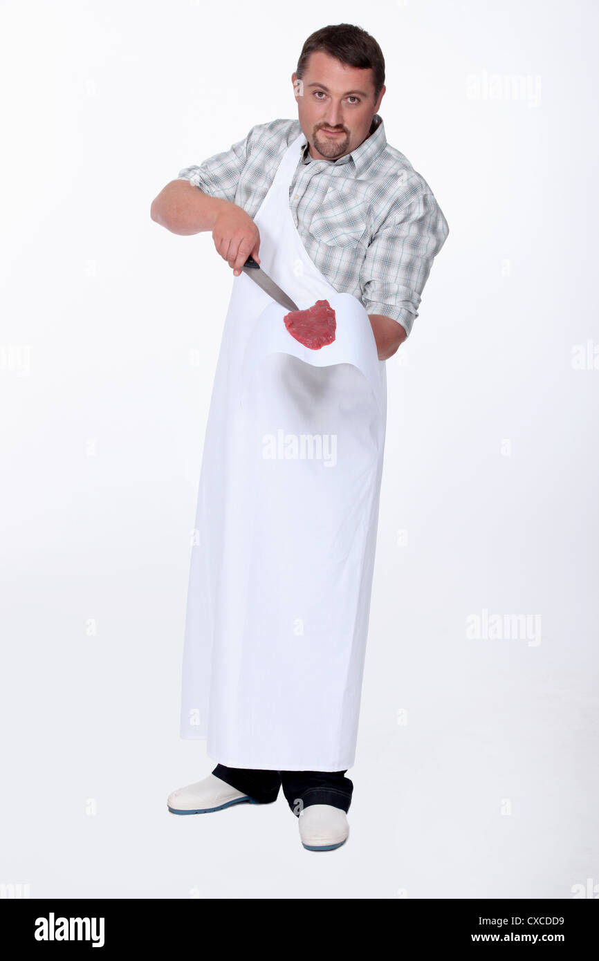 Butcher with knife and steak Stock Photo - Alamy
