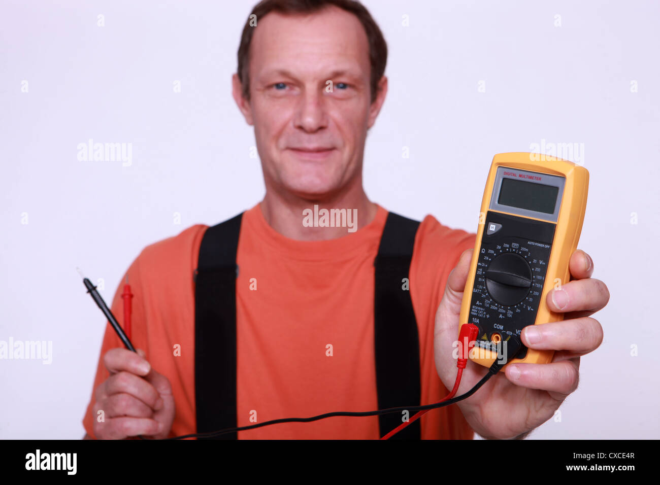 Man holding voltmeter Stock Photo - Alamy
