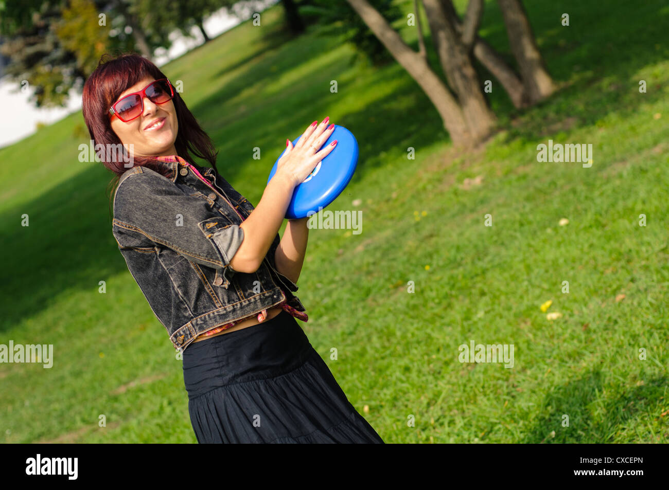 Young woman having fun with frisbee in the park sunny summer day Stock ...
