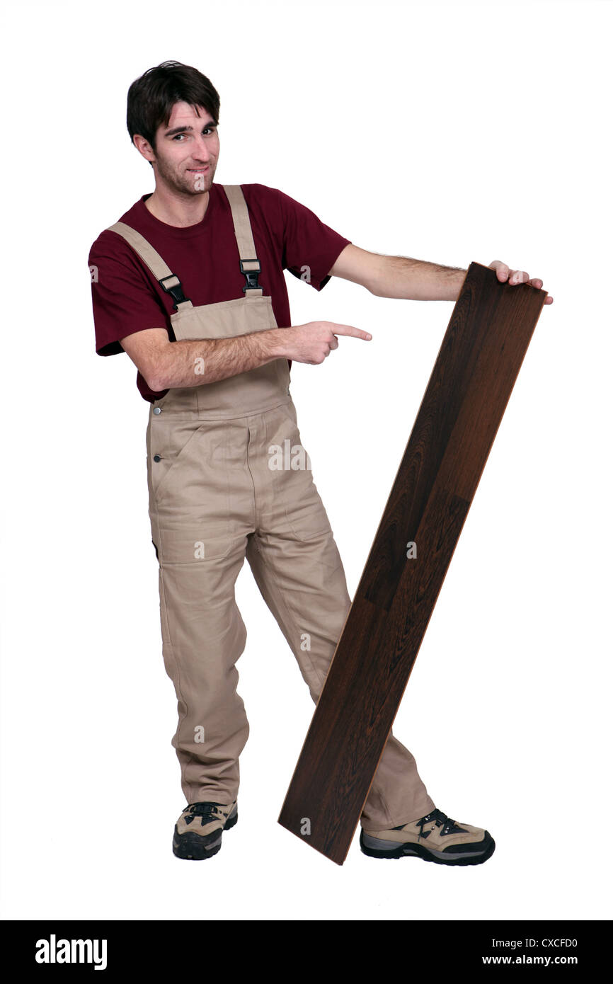 Man pointing a plank of flooring Stock Photo - Alamy