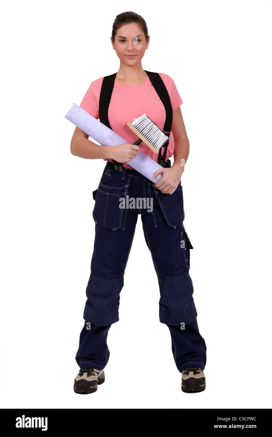 Decorator with wallpaper and a brush Stock Photo - Alamy