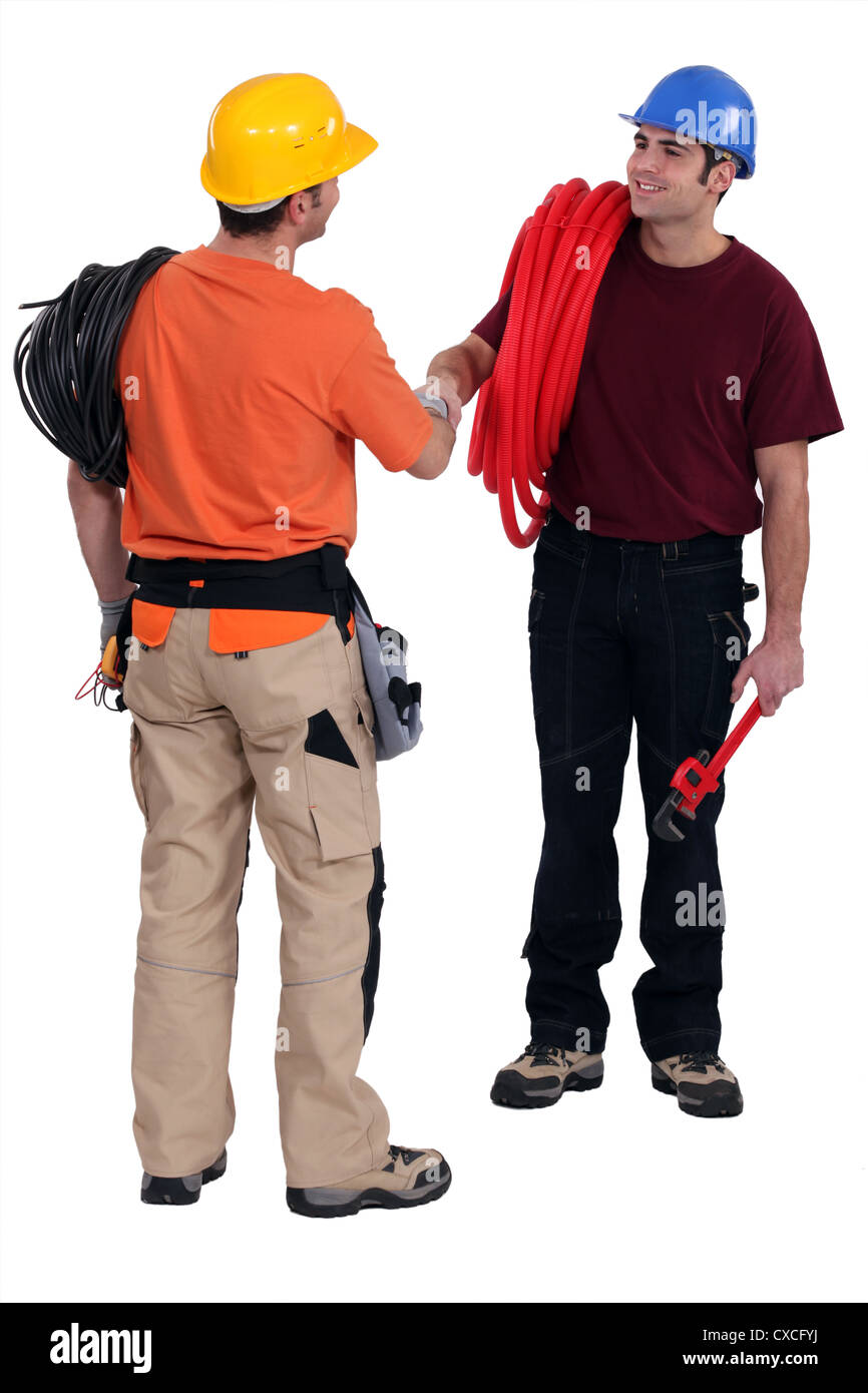 Tradesmen shaking hands in agreement Stock Photo - Alamy