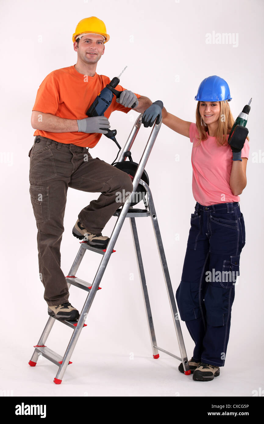 Tradesman posing with his young apprentice Stock Photo - Alamy