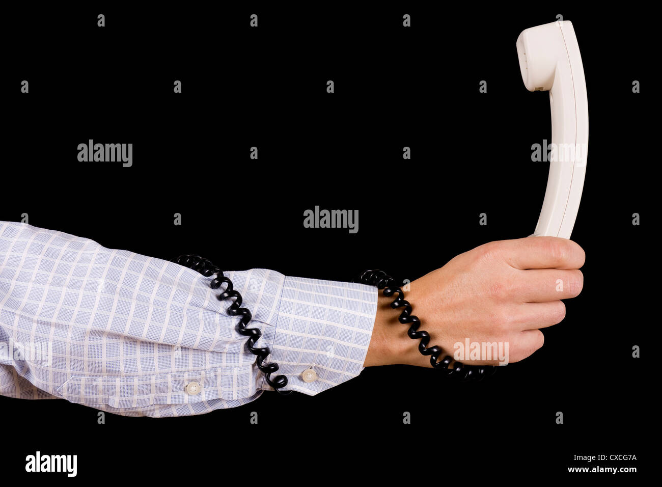 Man holding a telephone receiver with the cable around his arm Stock ...