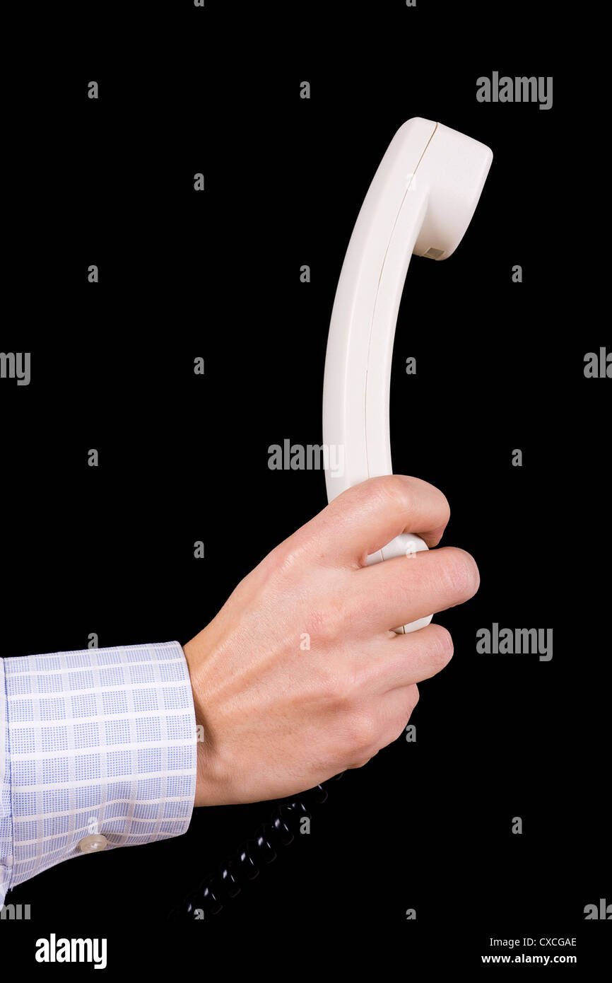 Man holding a telephone receiver isolated on black Stock Photo - Alamy
