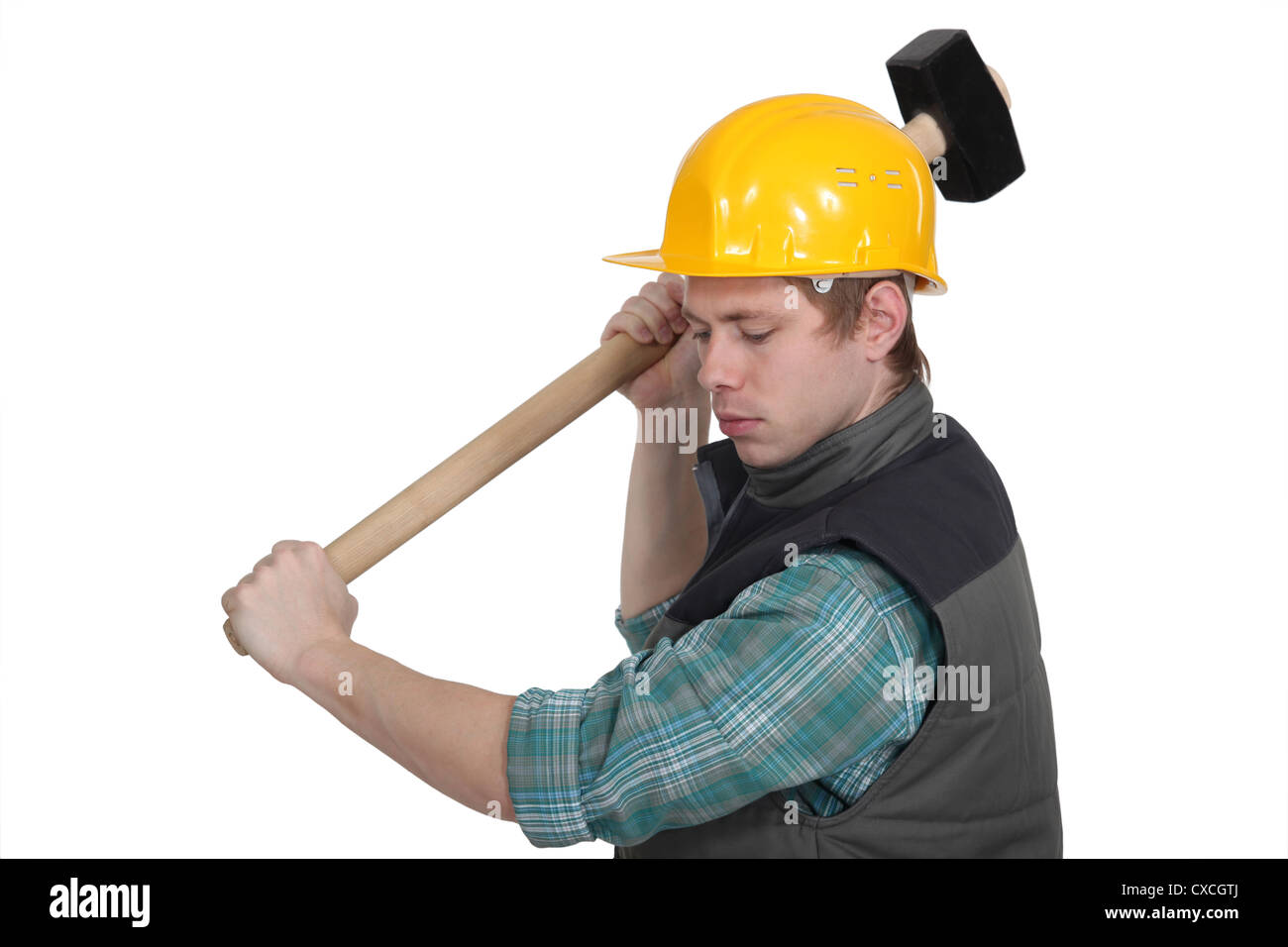 young craftsman working with a huge hammer Stock Photo - Alamy