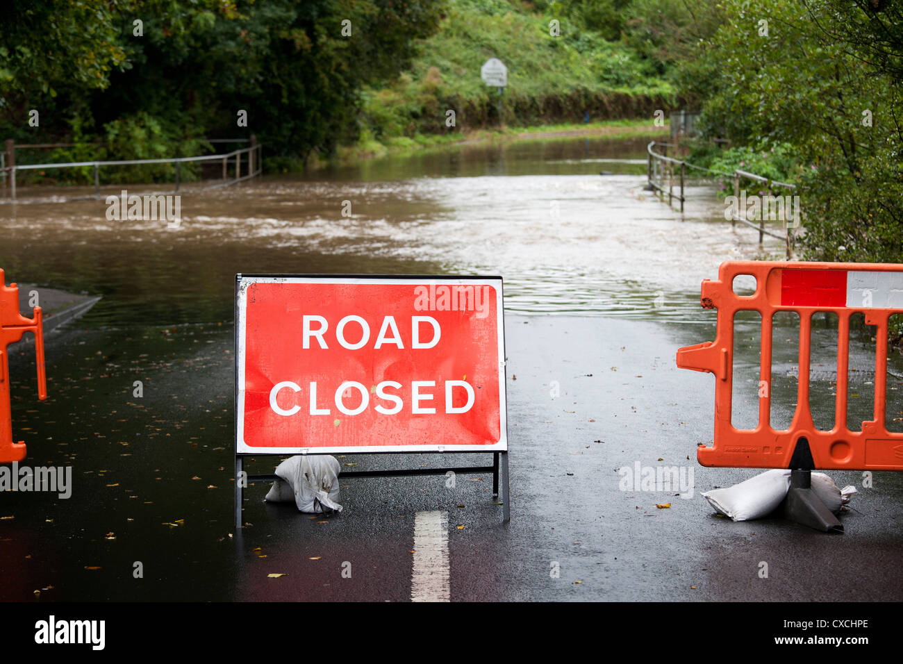 A Road Closed sign warning of deep water after torrential rain flooded ...