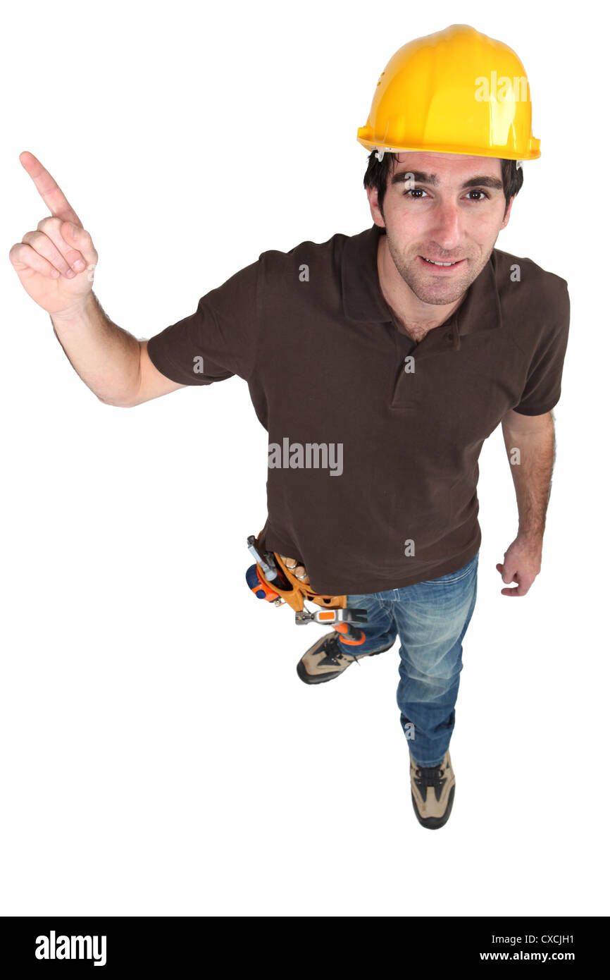 Builder pointing at copyspace Stock Photo - Alamy