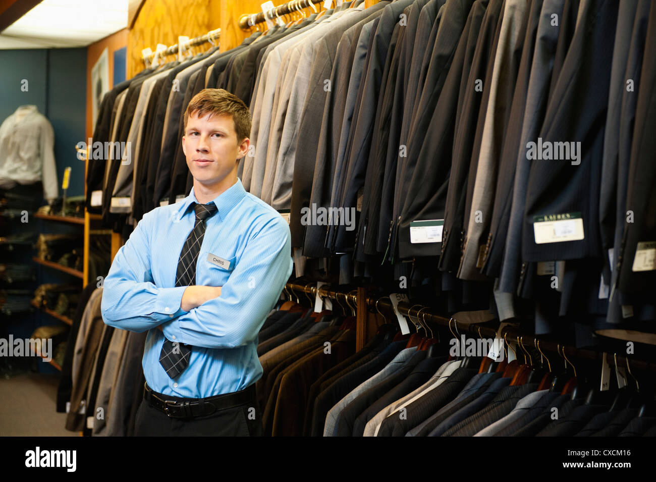 Caucasian man working in men's clothing store Stock Photo - Alamy