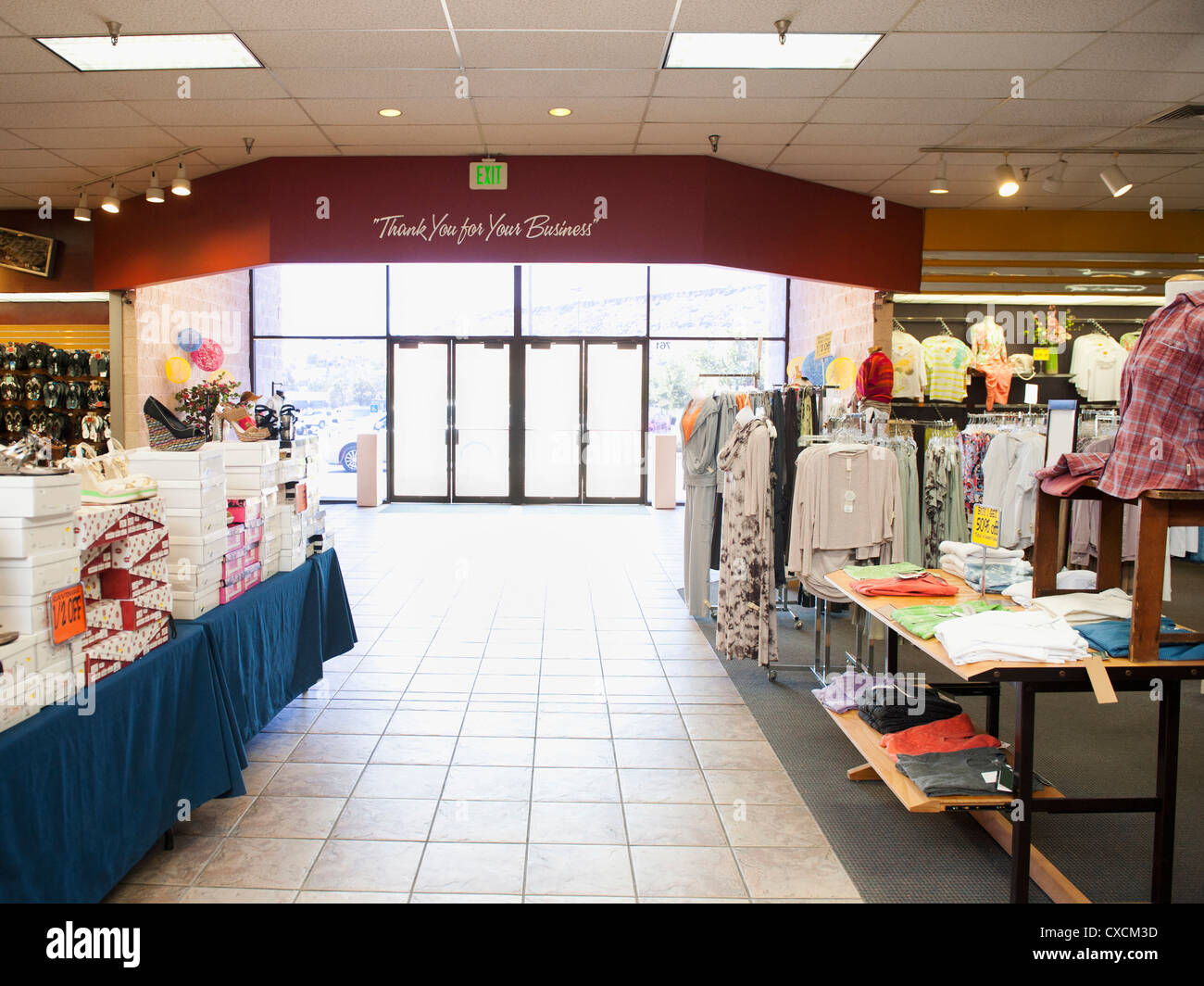 Clothes and shoes displayed in clothing store Stock Photo - Alamy