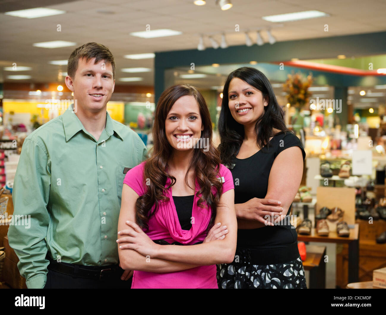 Co-workers standing in store together Stock Photo - Alamy