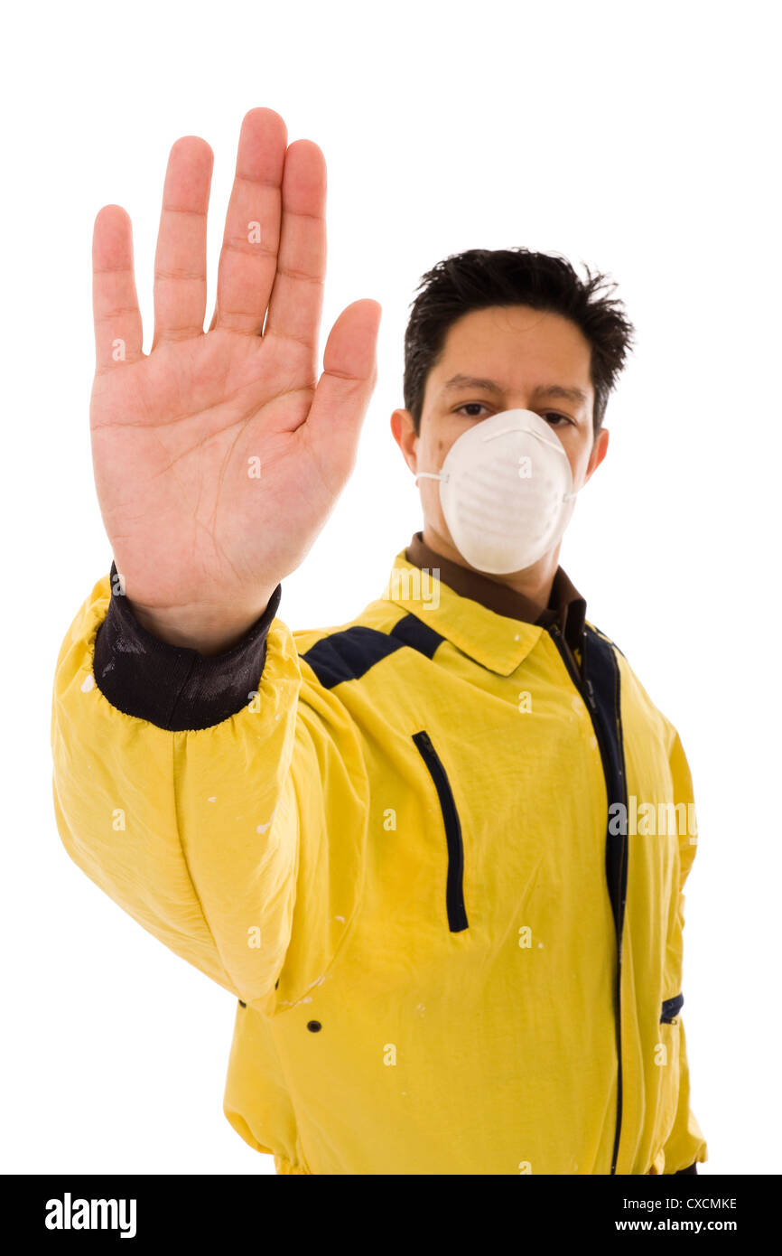 Engineer with yellow workwear and mask doing the stop gesture (focus on ...