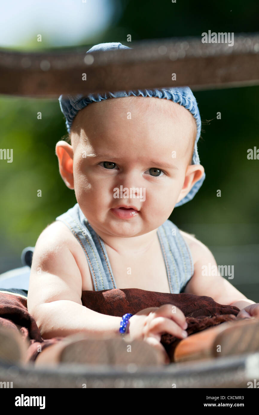 Sixth mounts old baby boy laying on a wooden bench Stock Photo - Alamy
