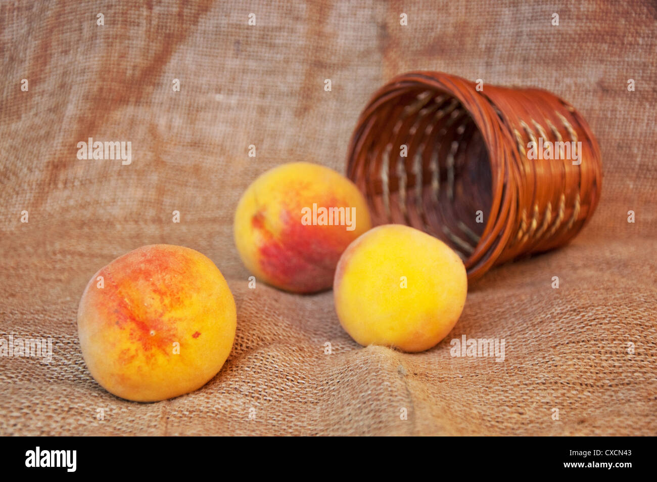 Tasty fresh ripe peaches and a punnet on a table Stock Photo - Alamy