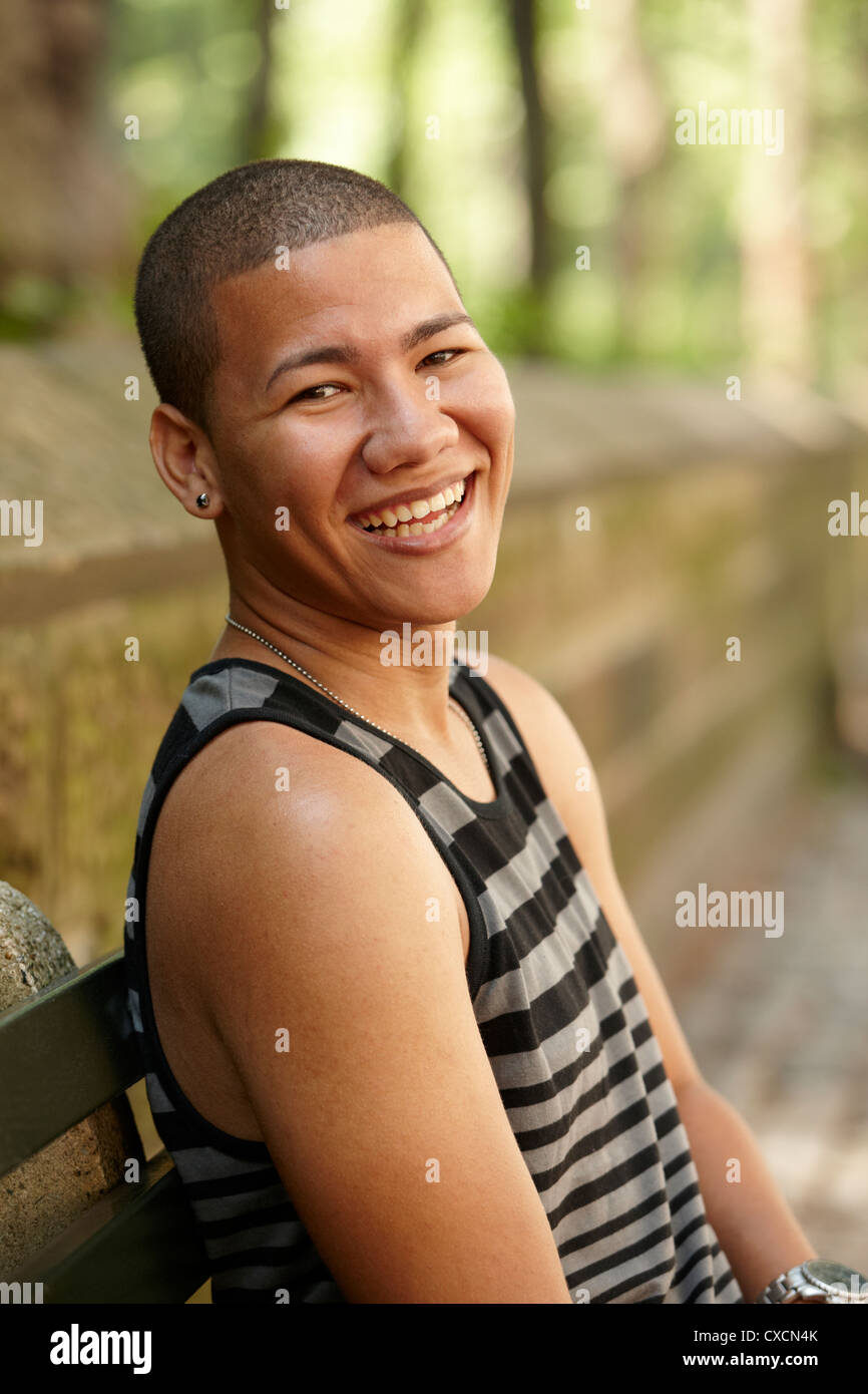 Smiling man sitting on bench outdoors Stock Photo - Alamy