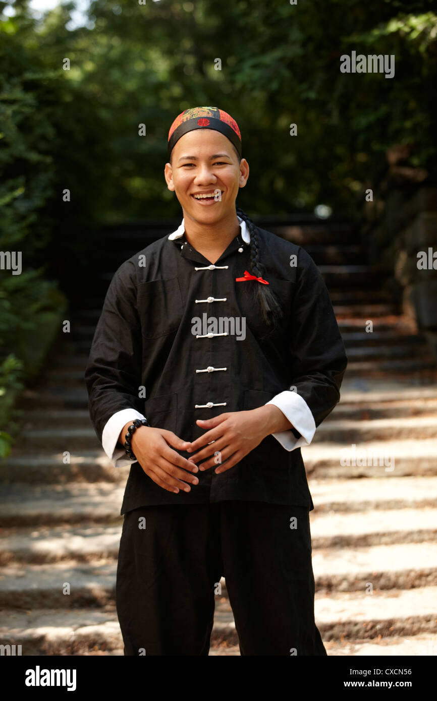 Smiling man in traditional Asian clothing Stock Photo - Alamy