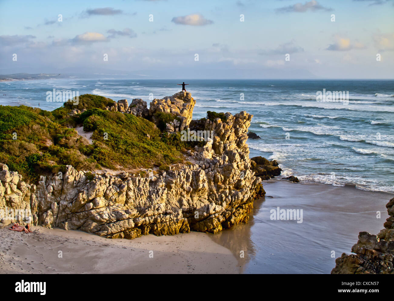 A man enjoying the vast view of land, sea and sky at Grotto Beach ...