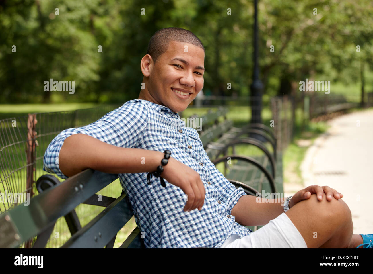 Man sitting on park bench Stock Photo - Alamy