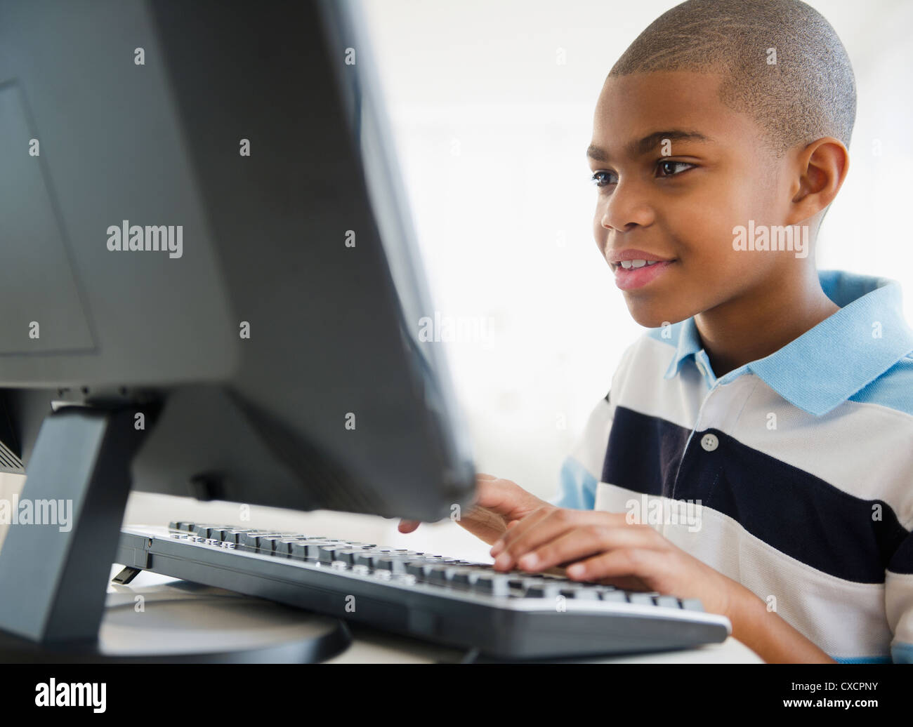 African American boy using computer Stock Photo - Alamy