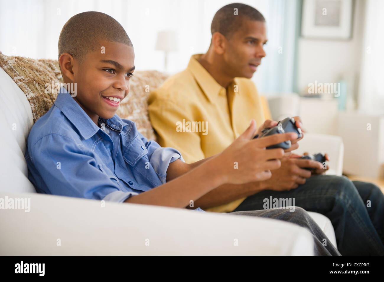 Father and son playing video games Stock Photo - Alamy