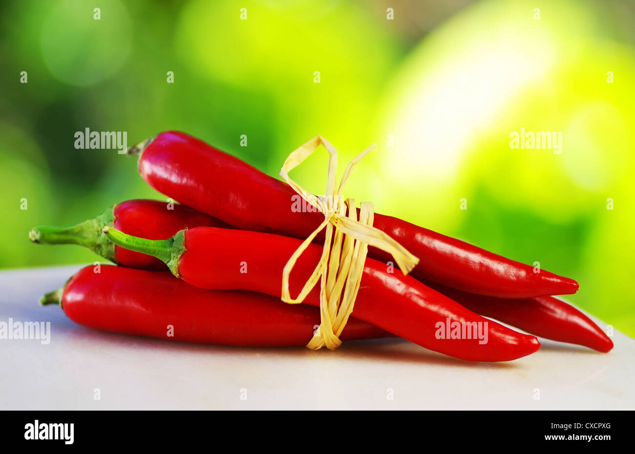 Red hot chili peppers tied with rope Stock Photo - Alamy