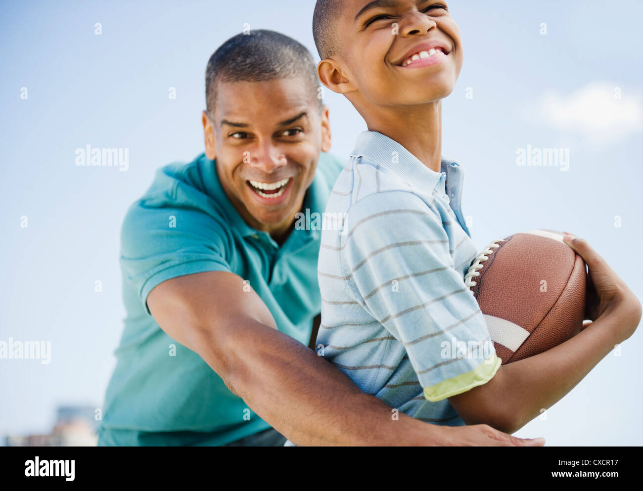 Father and son playing football Stock Photo - Alamy