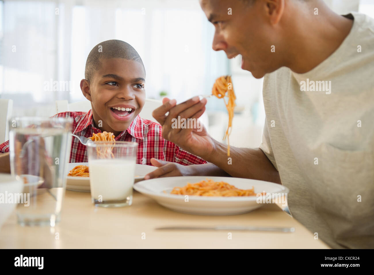 Father and son eating dinner Stock Photo - Alamy